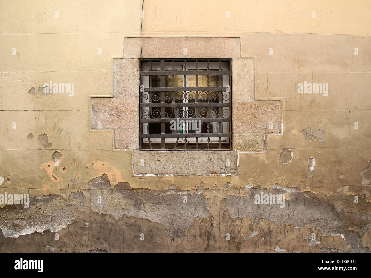 Window with metal grill in stone wall of old street in El Raval ...