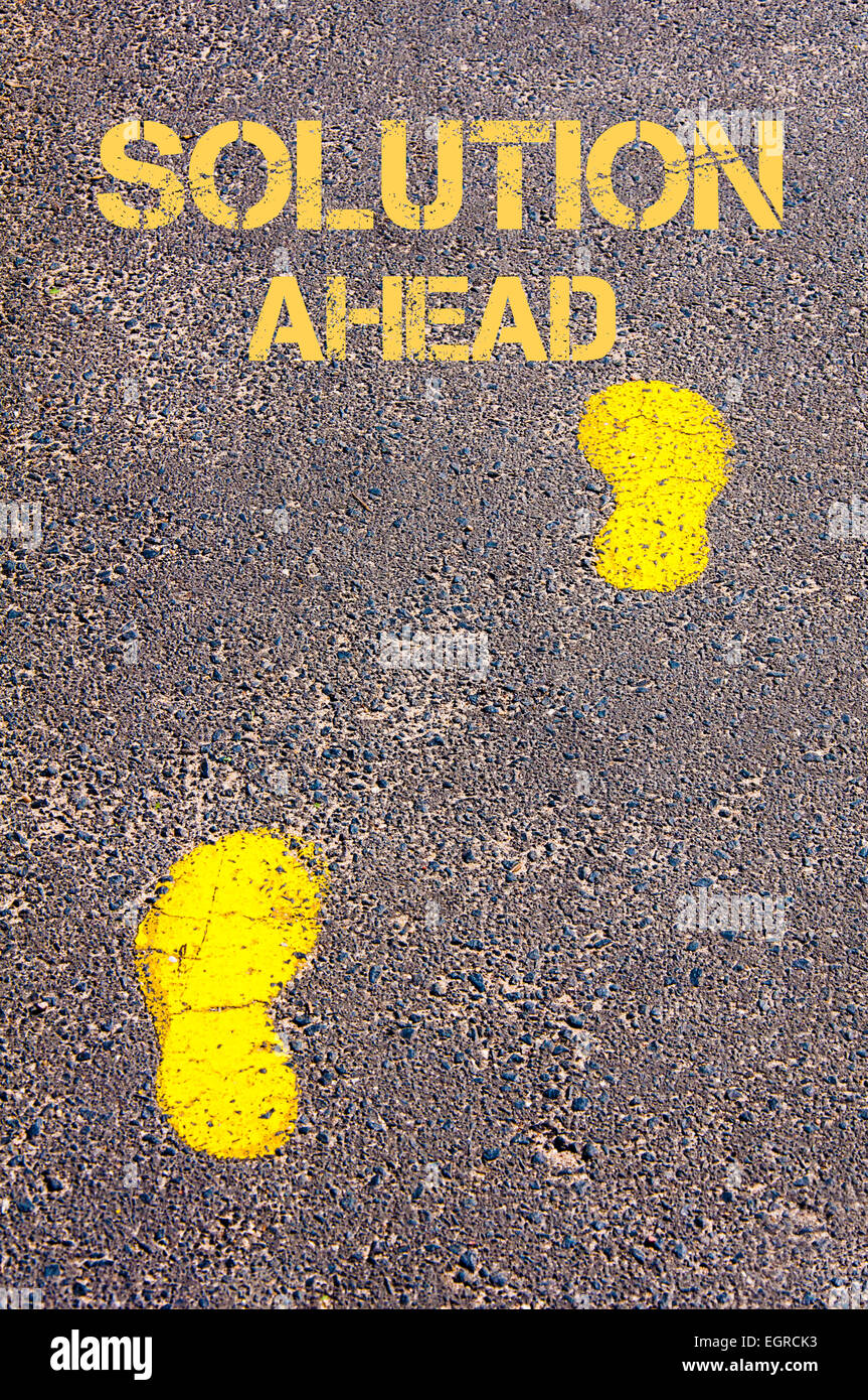 Yellow footsteps on sidewalk towards Solution Ahead message, Business ...