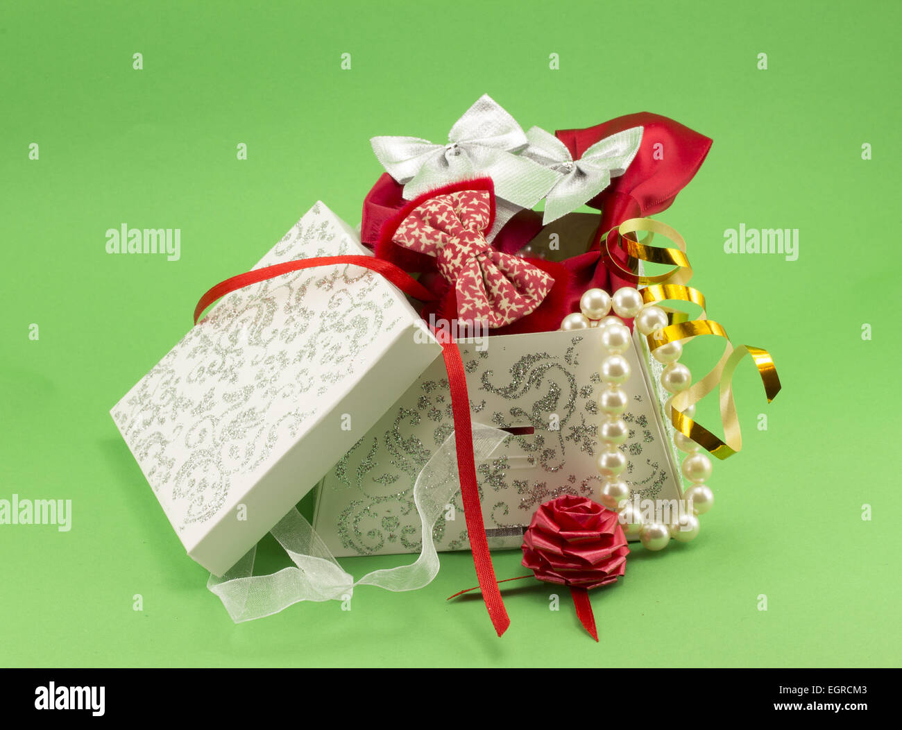 gift box isolated on a green background Stock Photo - Alamy