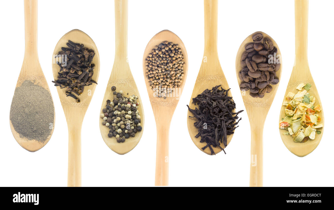 condiments, spices on wooden spoons isolated on white background Stock ...