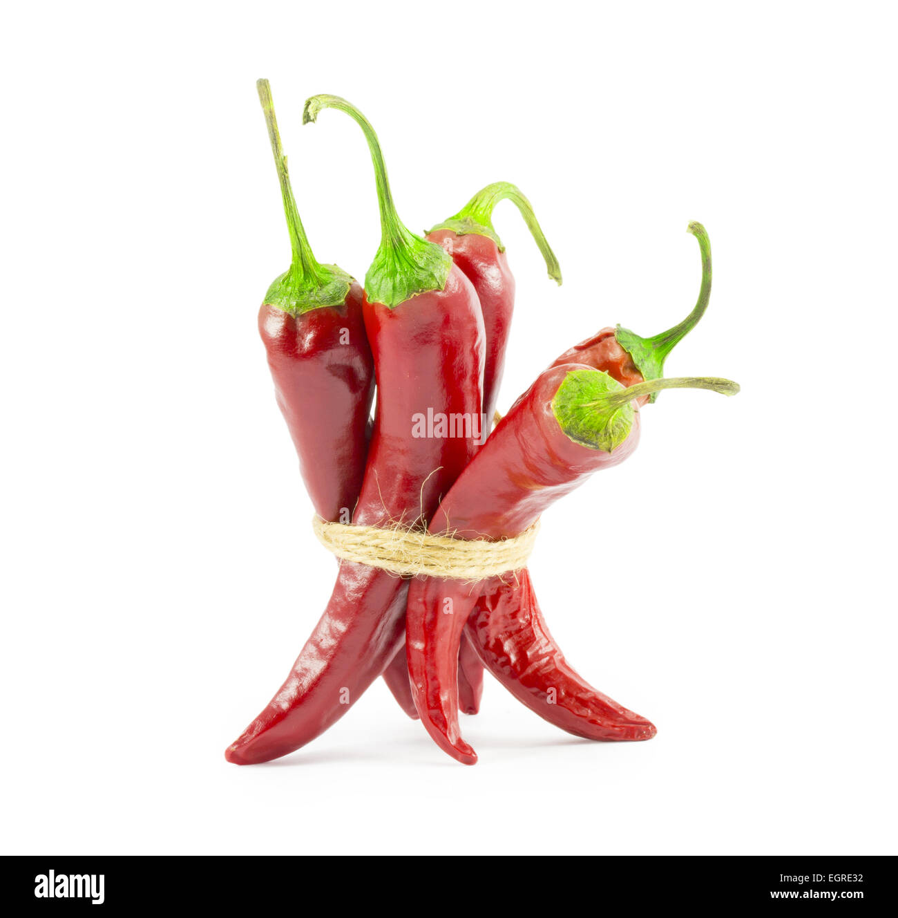 five red hot chili peppers tied together with rope Stock Photo - Alamy