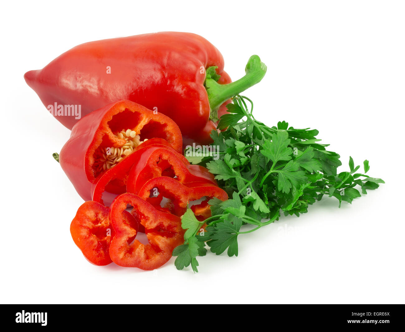 sliced red pepper and parsley on a white background Stock Photo - Alamy
