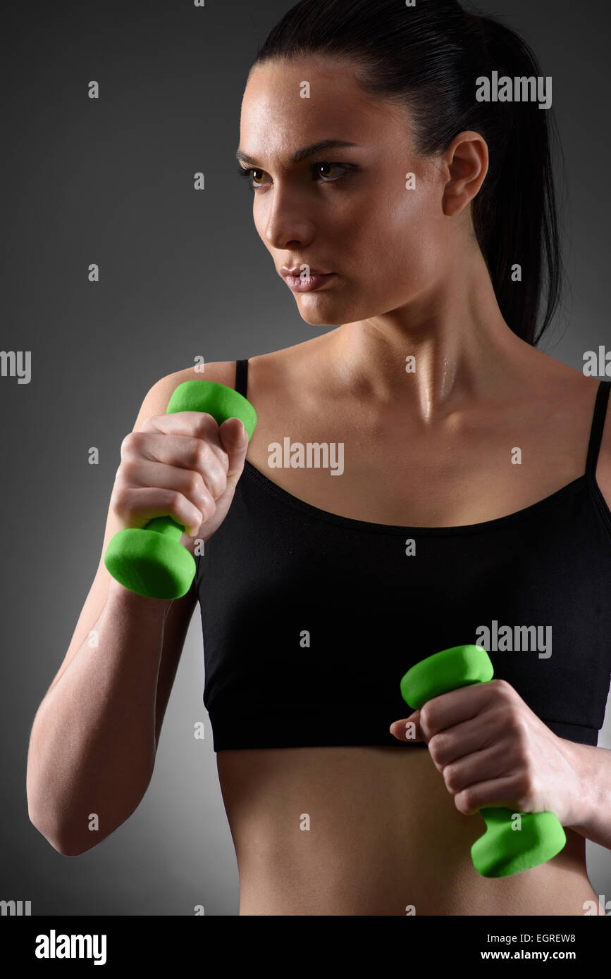 Fitness woman working out with green dumbbell Stock Photo - Alamy