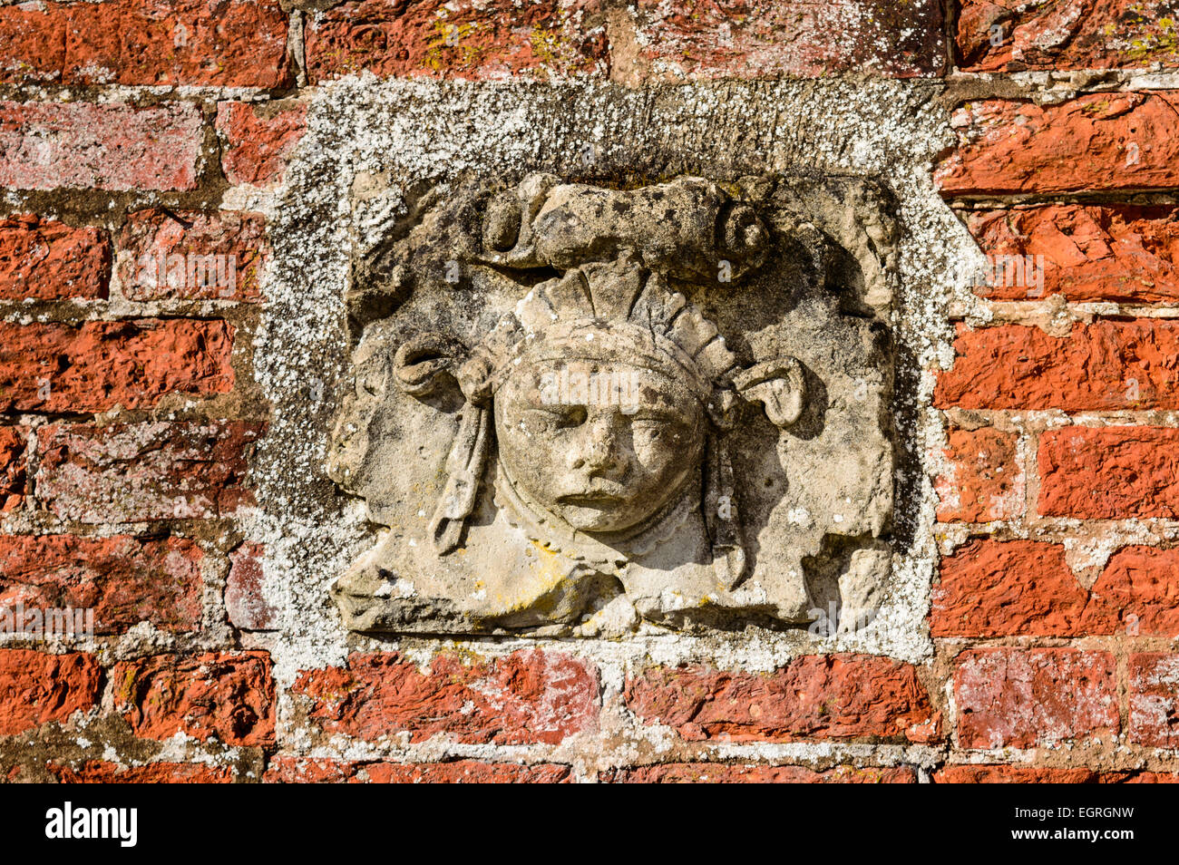 A decorative stone face on the brick wall in the Rose Gardens at ...