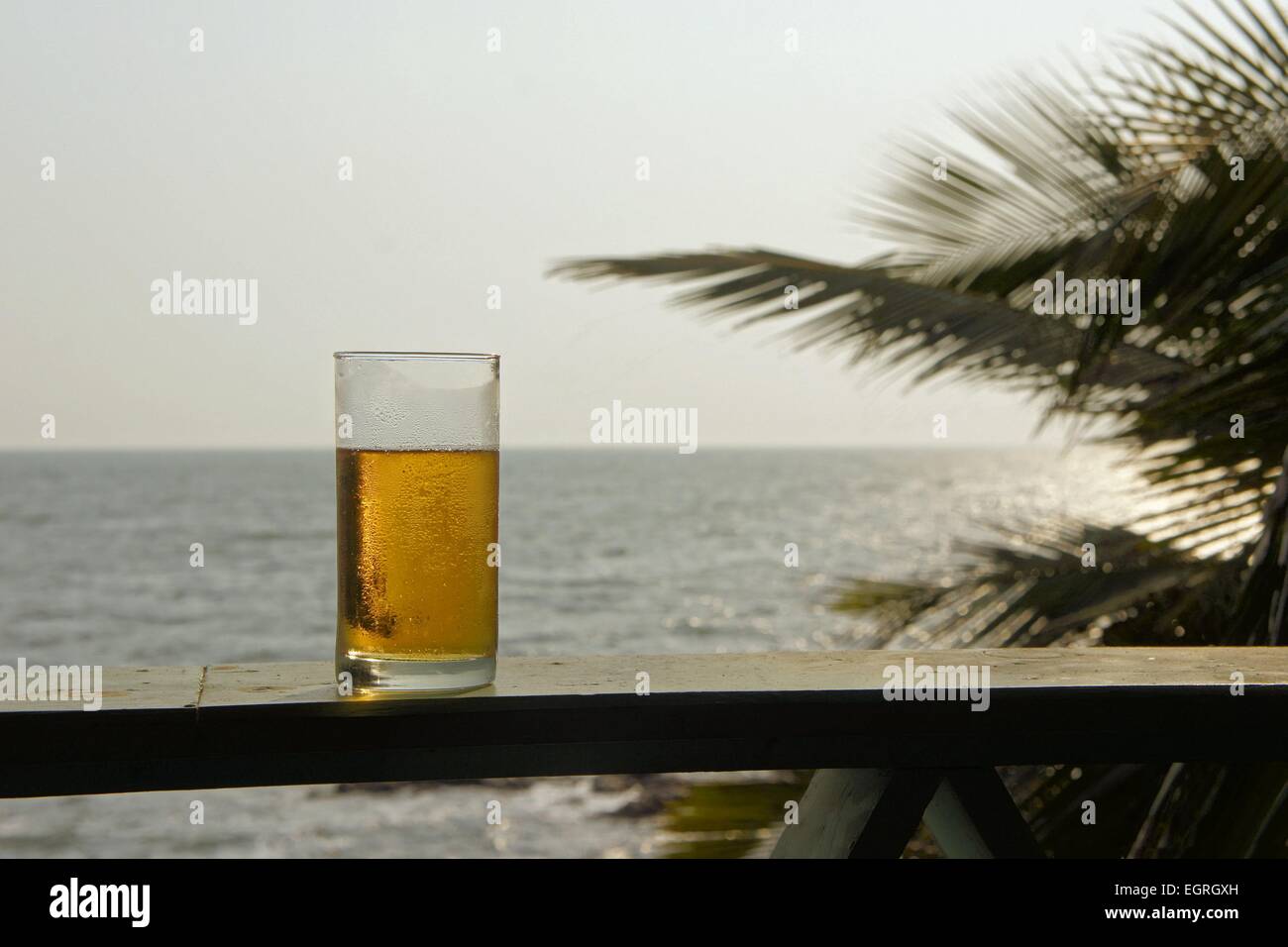 Glass of beer with sea background at the beach Stock Photo - Alamy