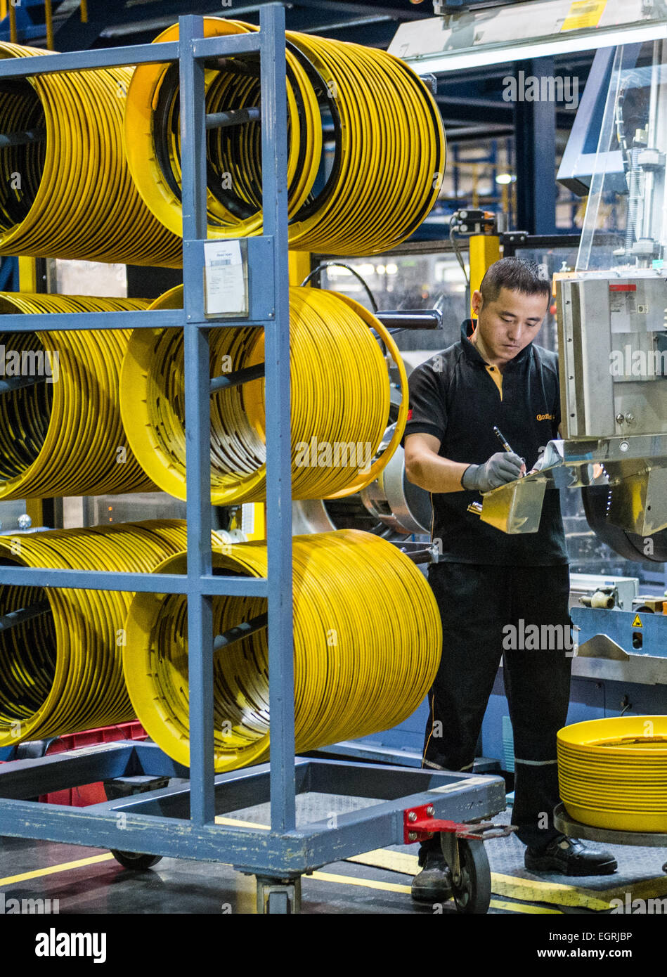 A worker takes note at the production site tires manufacturer ...