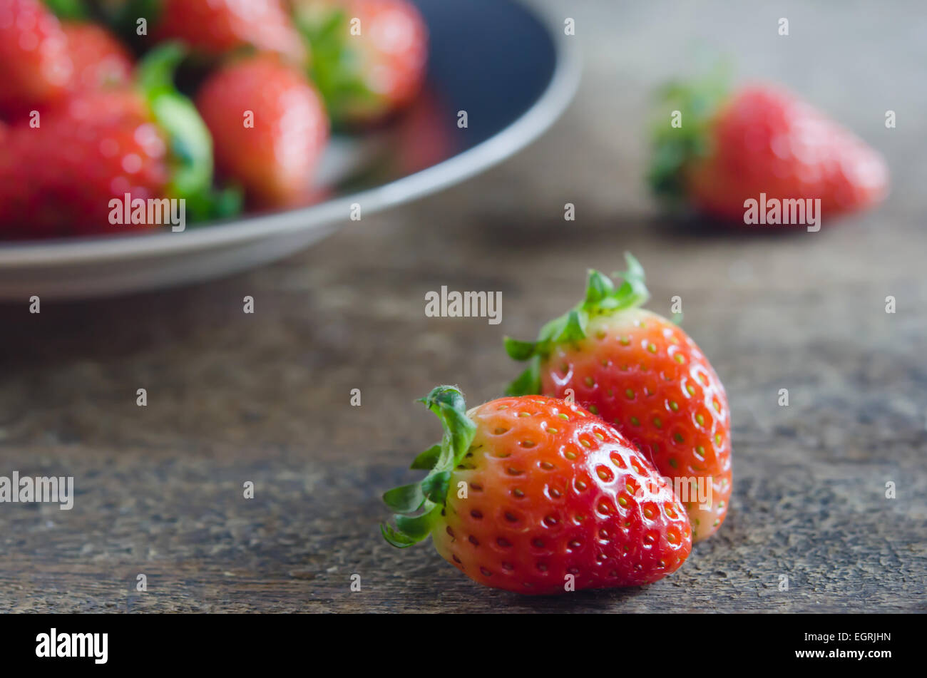 close up fresh red strawberries over wooden background Stock Photo - Alamy