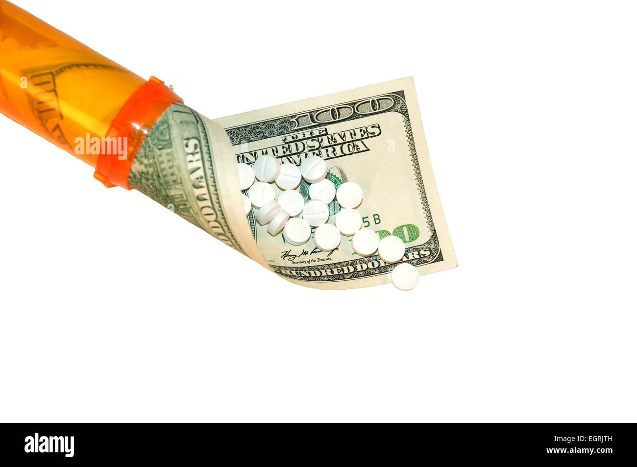 A prescription bottle with a $100 dollar bill spilling out with white ...