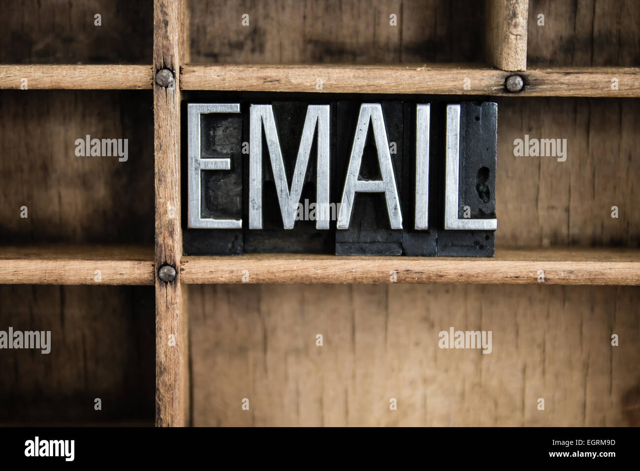 The word "EMAIL" written in vintage metal letterpress type in a wooden ...