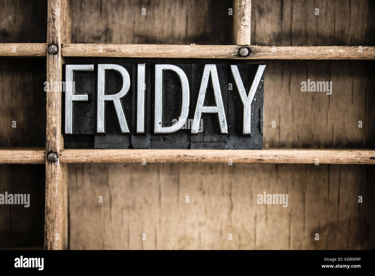The word "FRIDAY" written in vintage metal letterpress type in a wooden ...