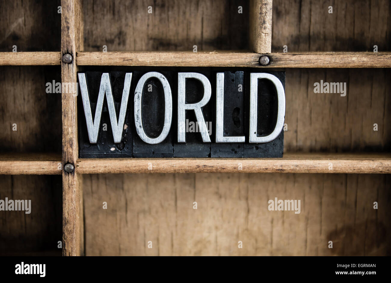 The word "WORLD" written in vintage metal letterpress type in a wooden ...