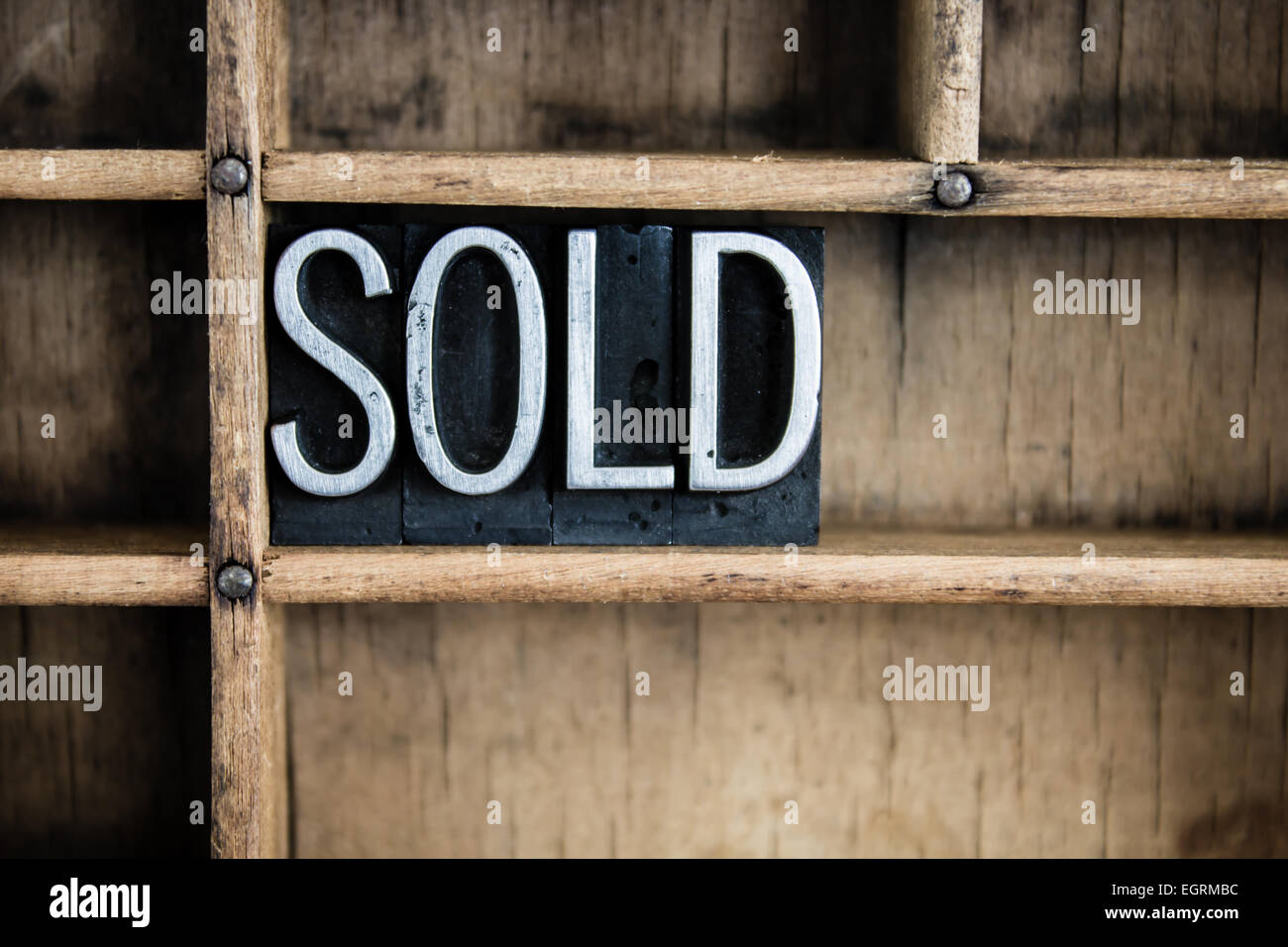 The word "SOLD" written in vintage metal letterpress type in a wooden ...