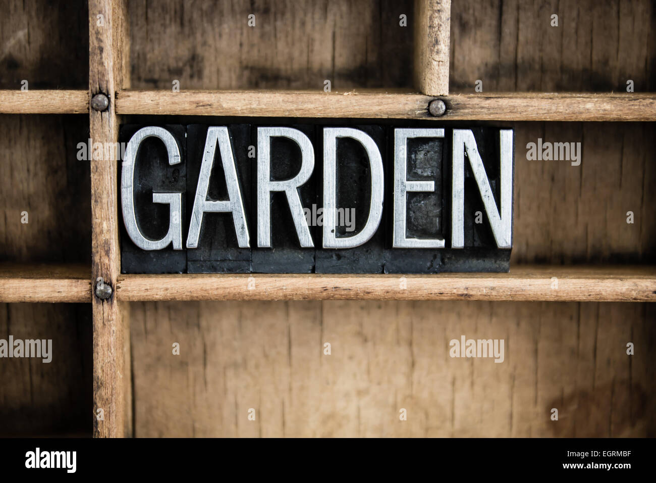 The word "GARDEN" written in vintage metal letterpress type in a wooden ...