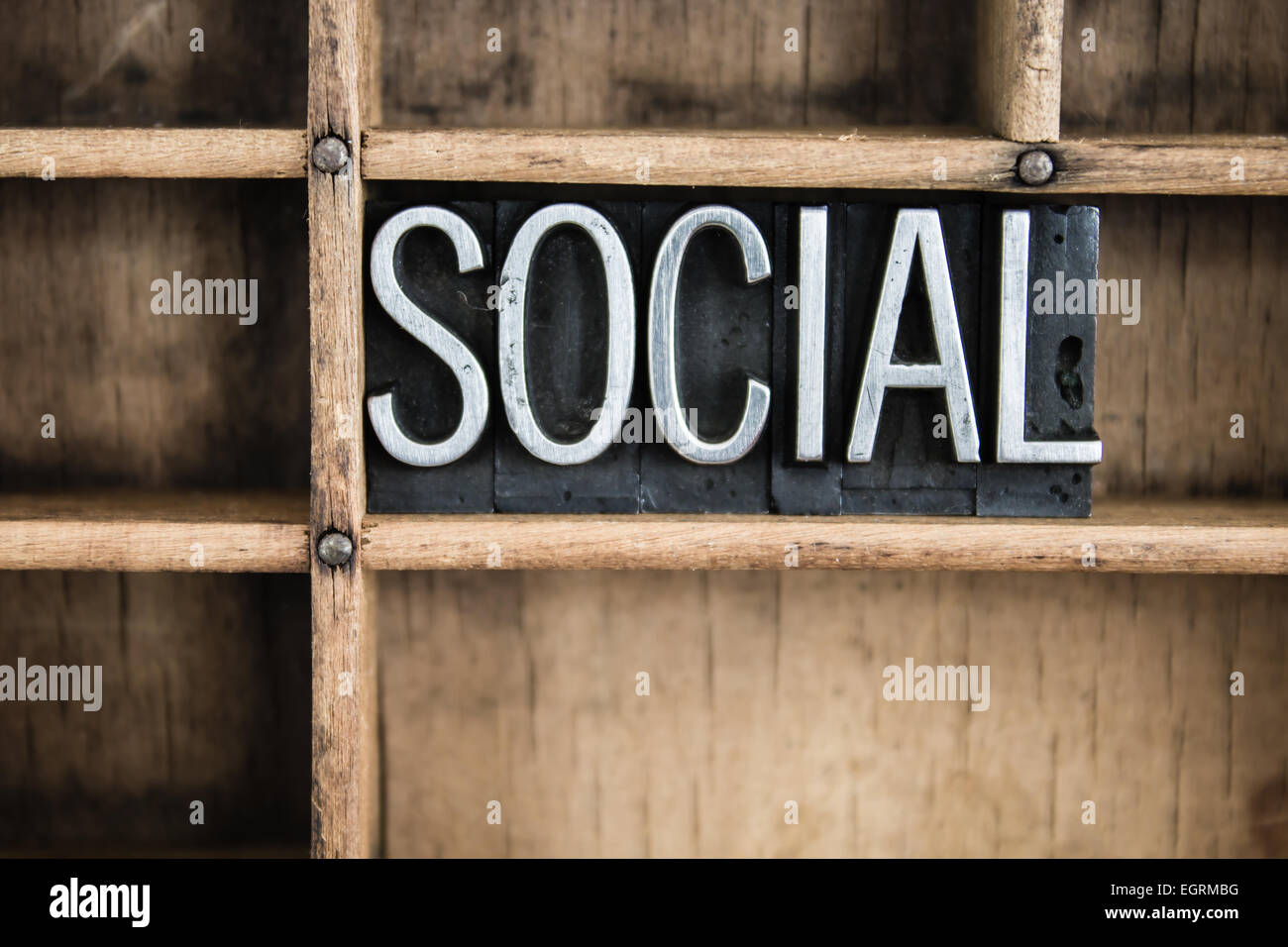 The word "SOCIAL" written in vintage metal letterpress type in a wooden ...