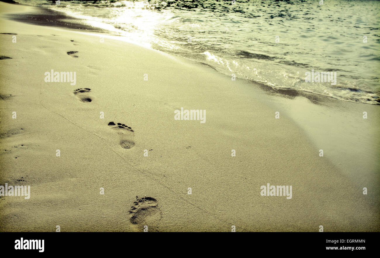Footsteps in the sand on the beach Stock Photo - Alamy