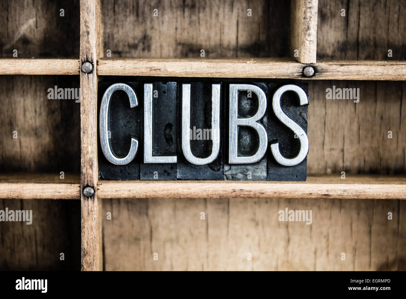 The word "CLUBS" written in vintage metal letterpress type in a wooden ...