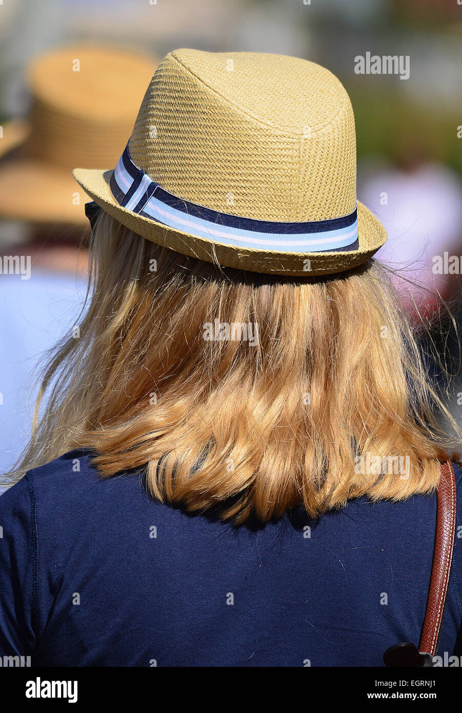 Blonde lady wearing straw hat on a sunny day at the seaside Stock Photo ...