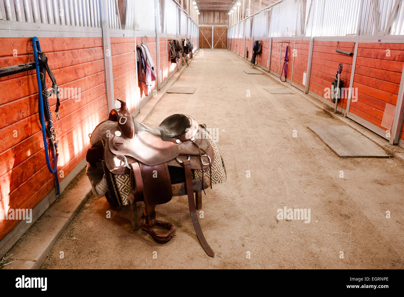 A saddle waits to be mounted on horses back at stables Stock Photo - Alamy