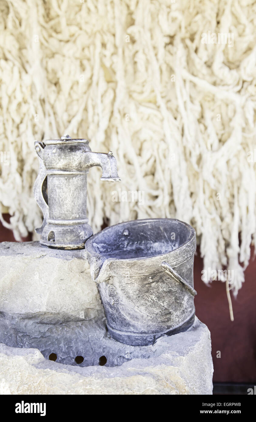 Water fountain with a bucket, detail of a water container grab Stock ...
