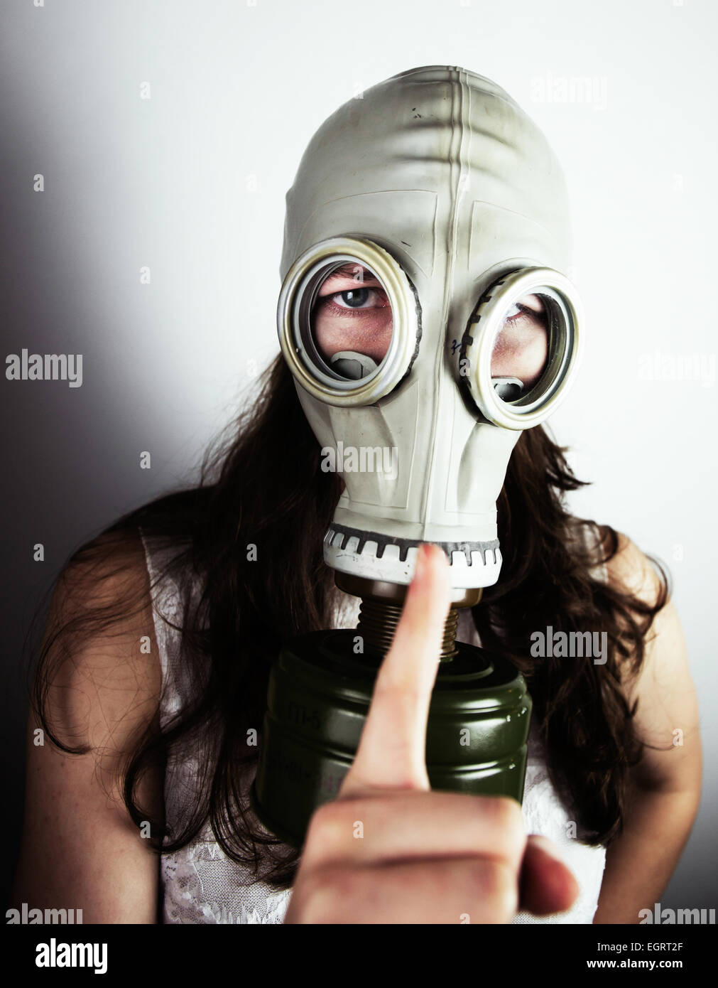 Woman wearing gas mask close-up with one finger held up Stock Photo - Alamy