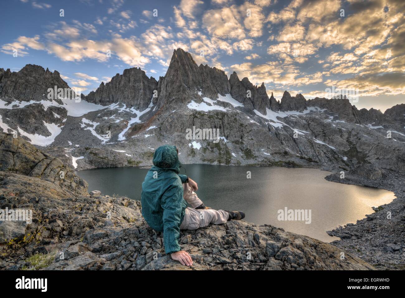 A hiker enjoys the view of the Minarets in the Sierra Nevada Mountains ...