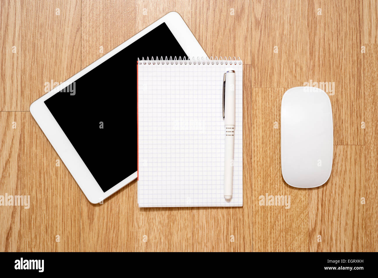 Digital tablet on wooden tablets with notepad and pen Stock Photo - Alamy