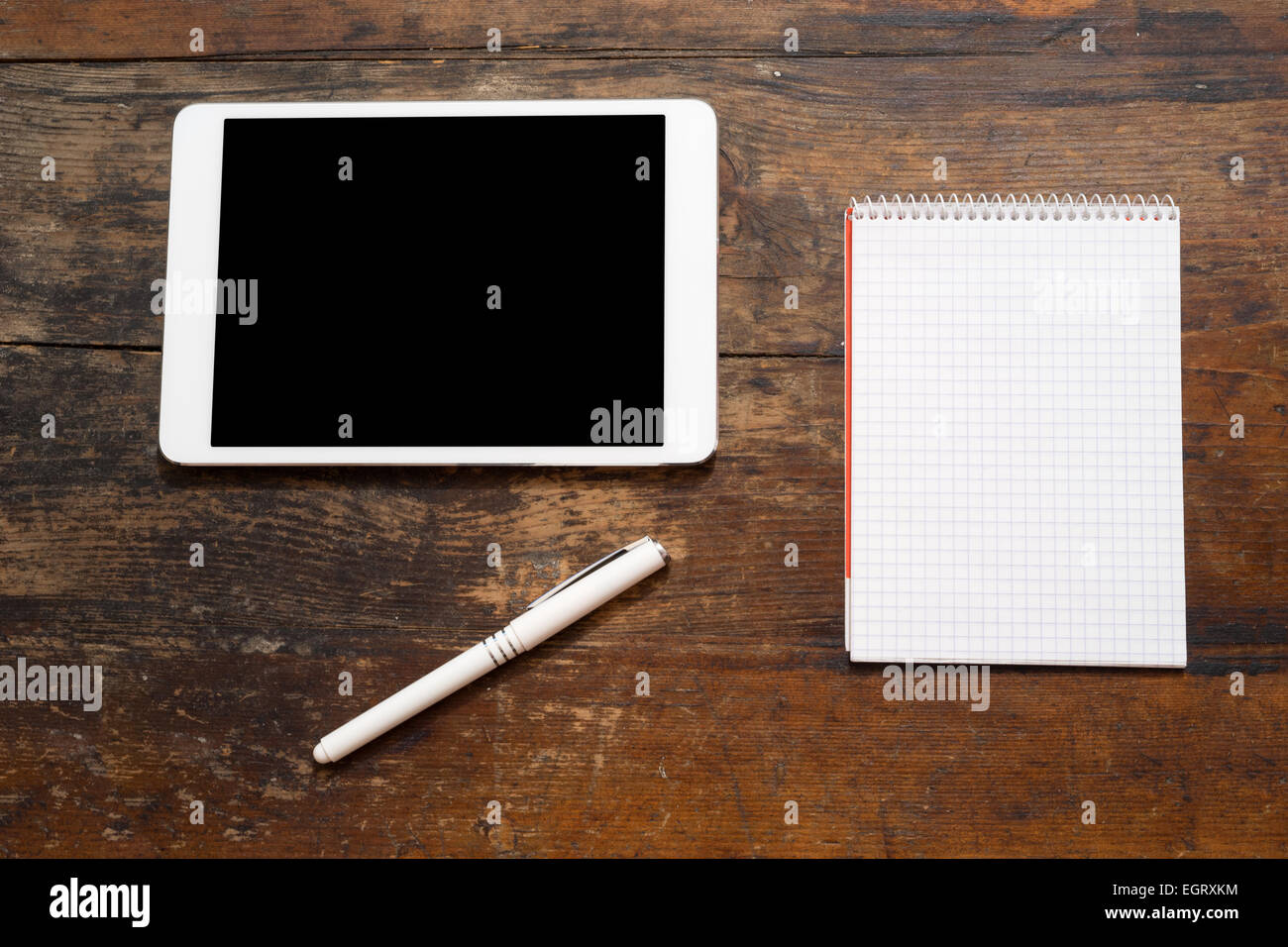 Digital tablet on wooden tablets with notepad and pen Stock Photo - Alamy