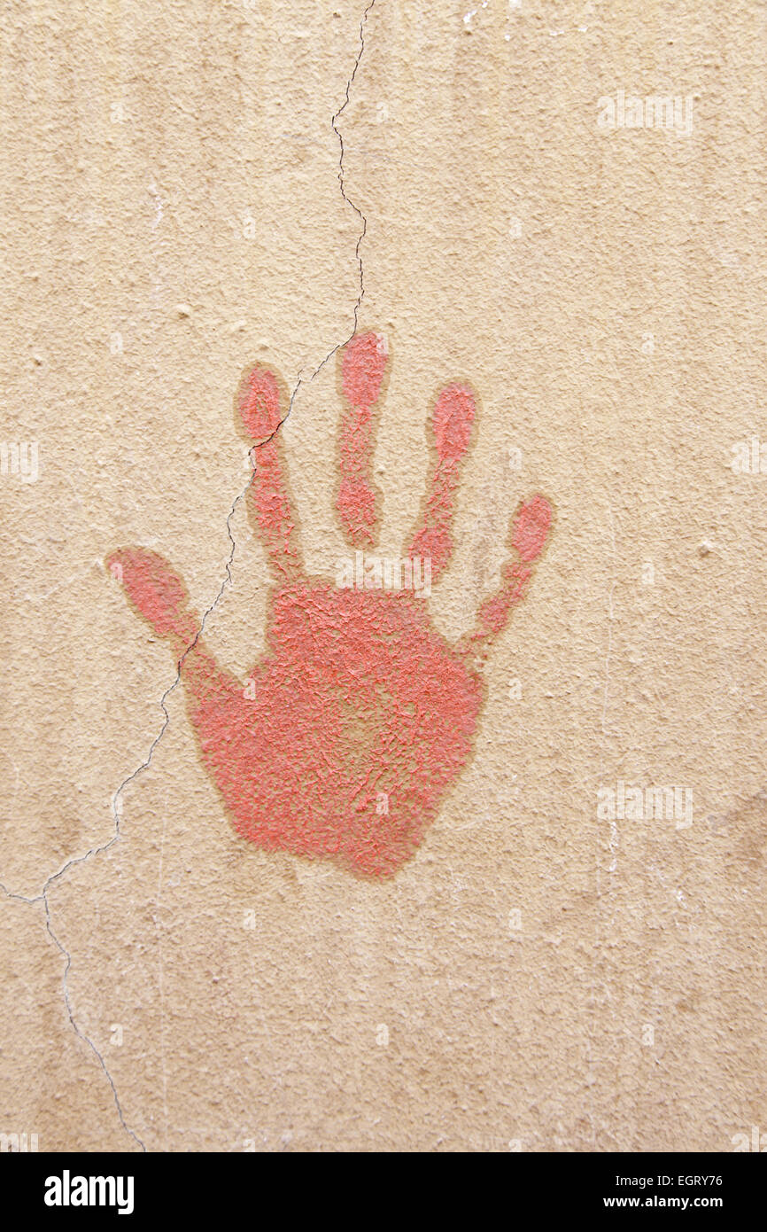 Hand painted on a wall, detail of a handprint, shape and texture ...