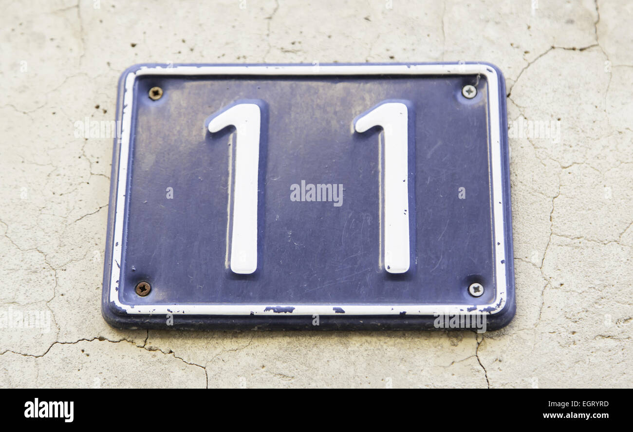 Number eleven a wall of a house, detail of a number of information, odd ...