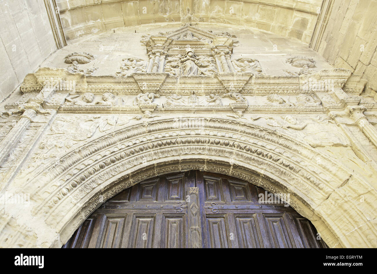 Ancient arch in a doorway in a church, detail of religious architecture ...