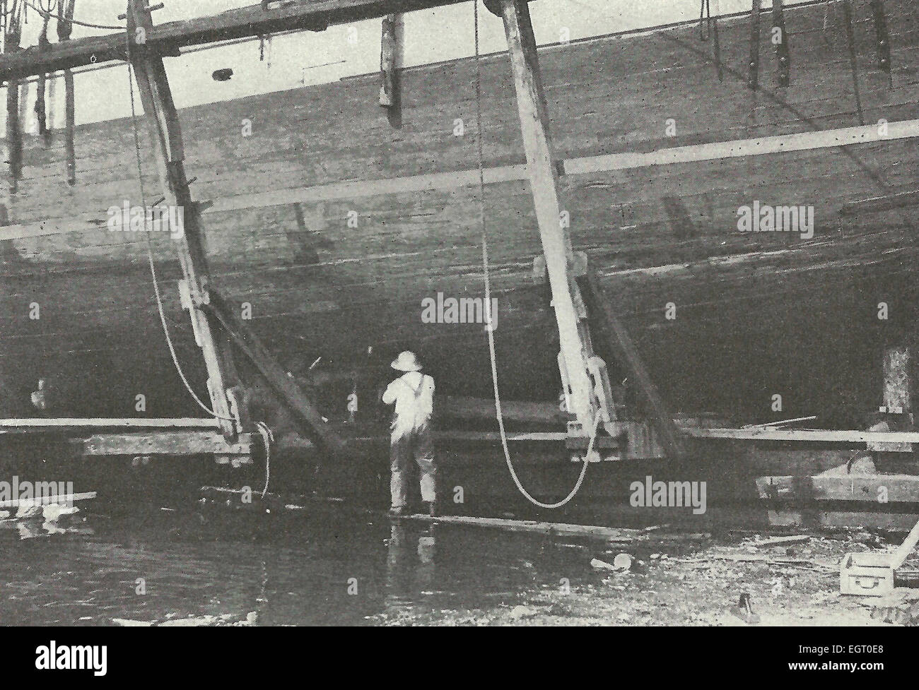 Patching up and caulking an old vessel, shipbuilding in Maine, 1916 ...