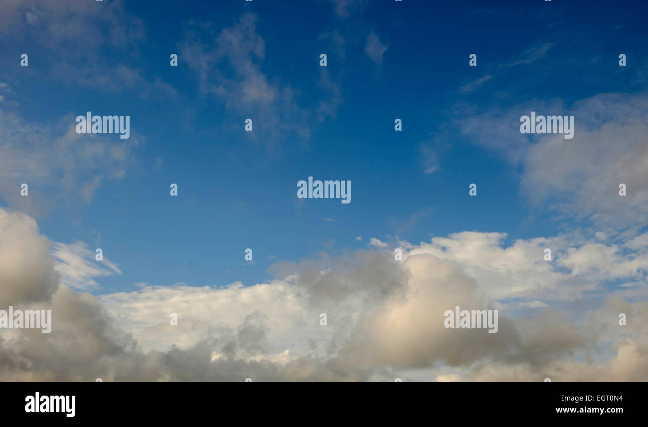 Clouds on lower third with mostly blue sky above Stock Photo - Alamy