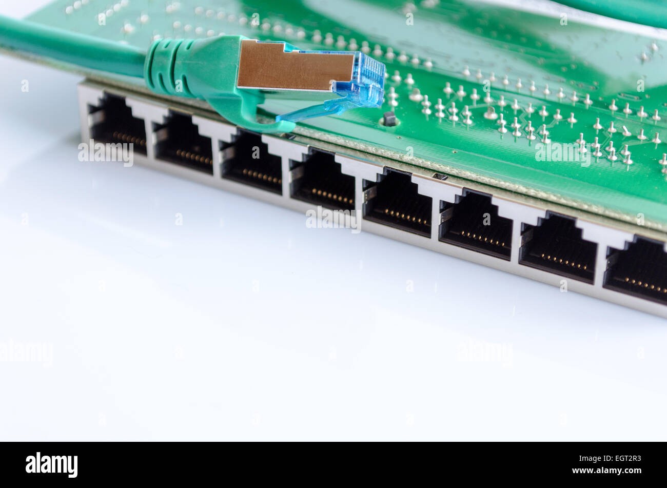 Green network cable and switch on white Stock Photo - Alamy