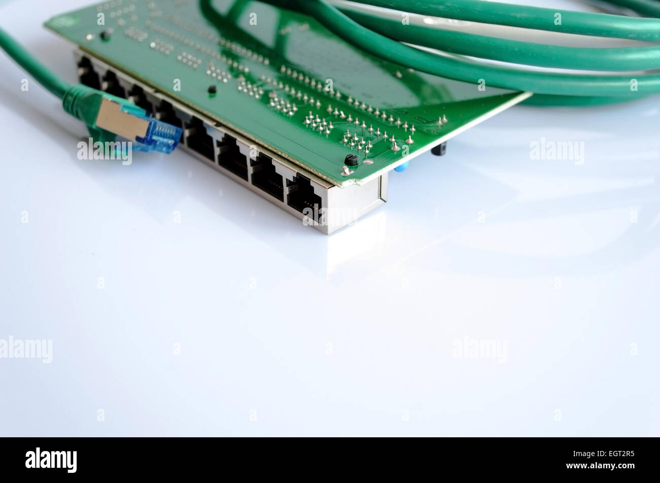 Green network cable and switch on white Stock Photo - Alamy