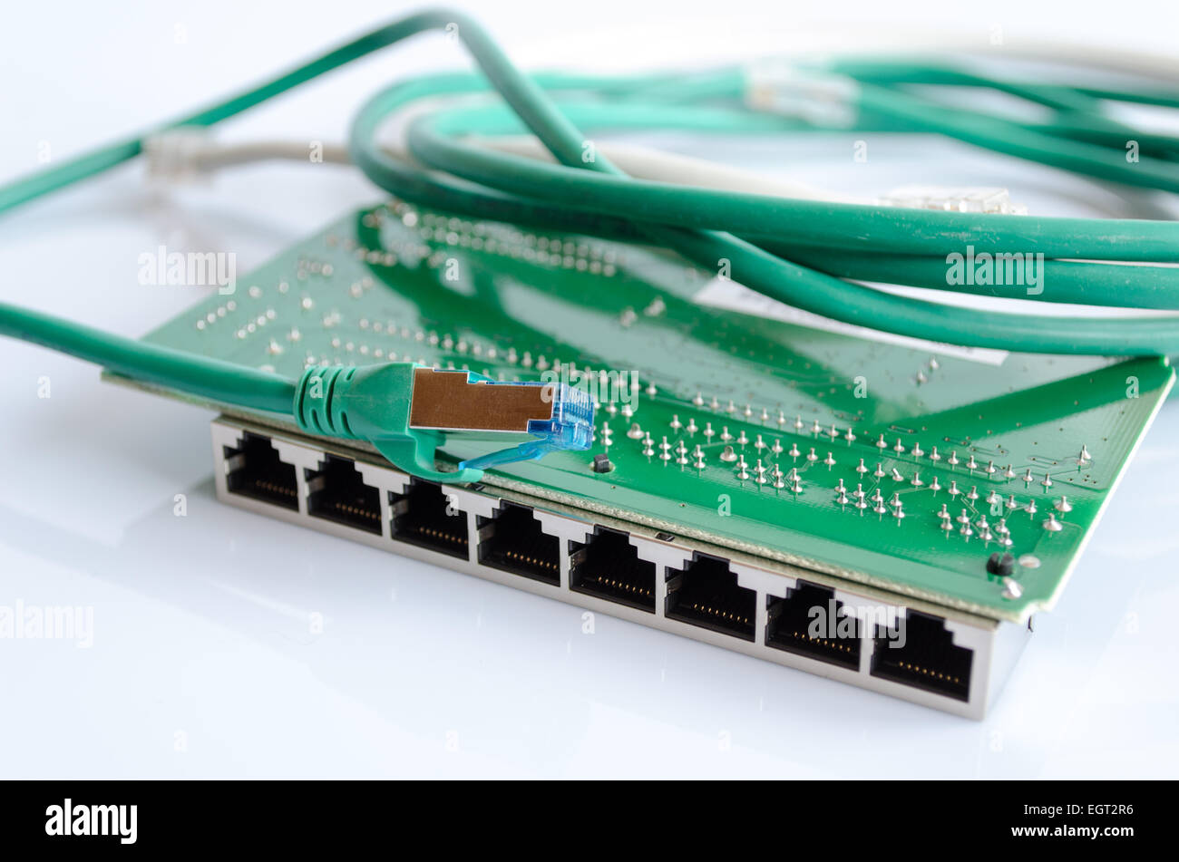 Green network cable and switch on white Stock Photo - Alamy