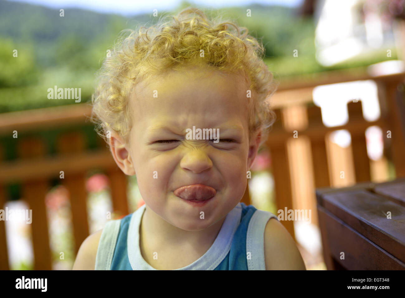 child makes a grimace and smile Stock Photo - Alamy