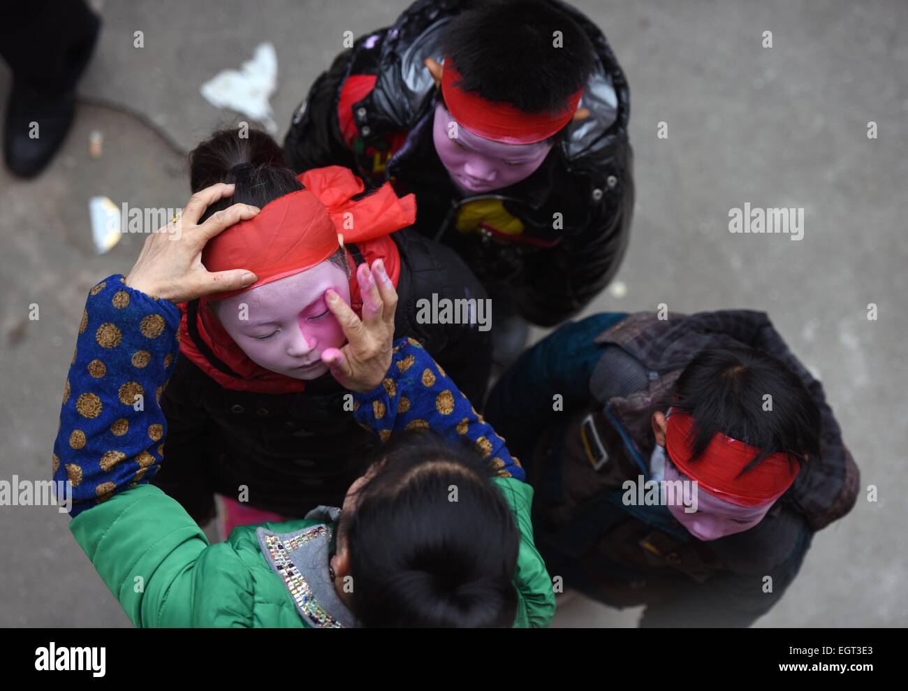Miluo, China's Hunan Province. 2nd Mar, 2015. A woman paints faces for ...