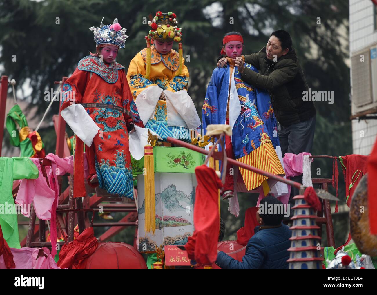 Miluo, China's Hunan Province. 2nd Mar, 2015. A man makes up children ...