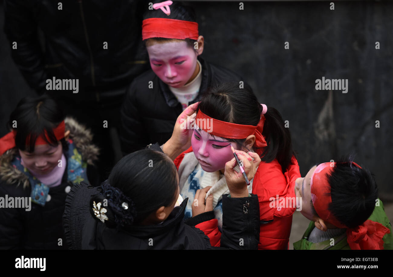 Miluo, China's Hunan Province. 2nd Mar, 2015. A woman paints faces for ...