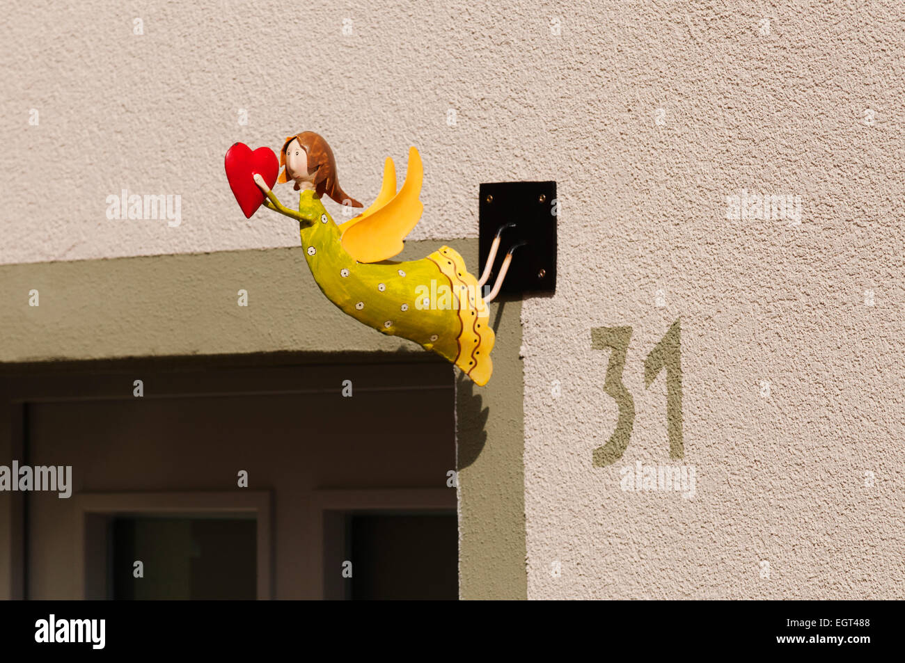 Angel carrying a heart outside the entrance to a Bamberg house Stock ...