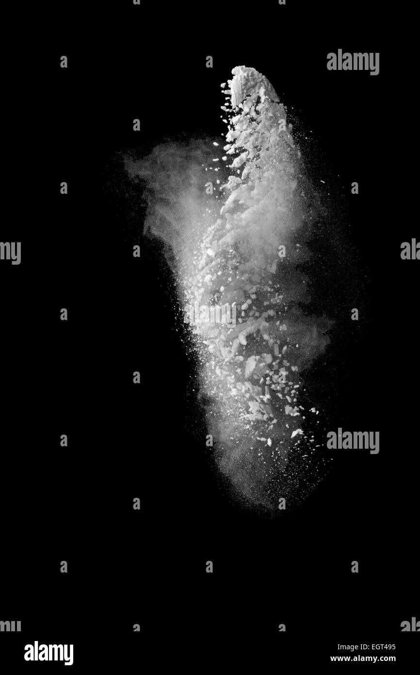 Freeze motion of white dust explosion isolated on black Stock Photo - Alamy