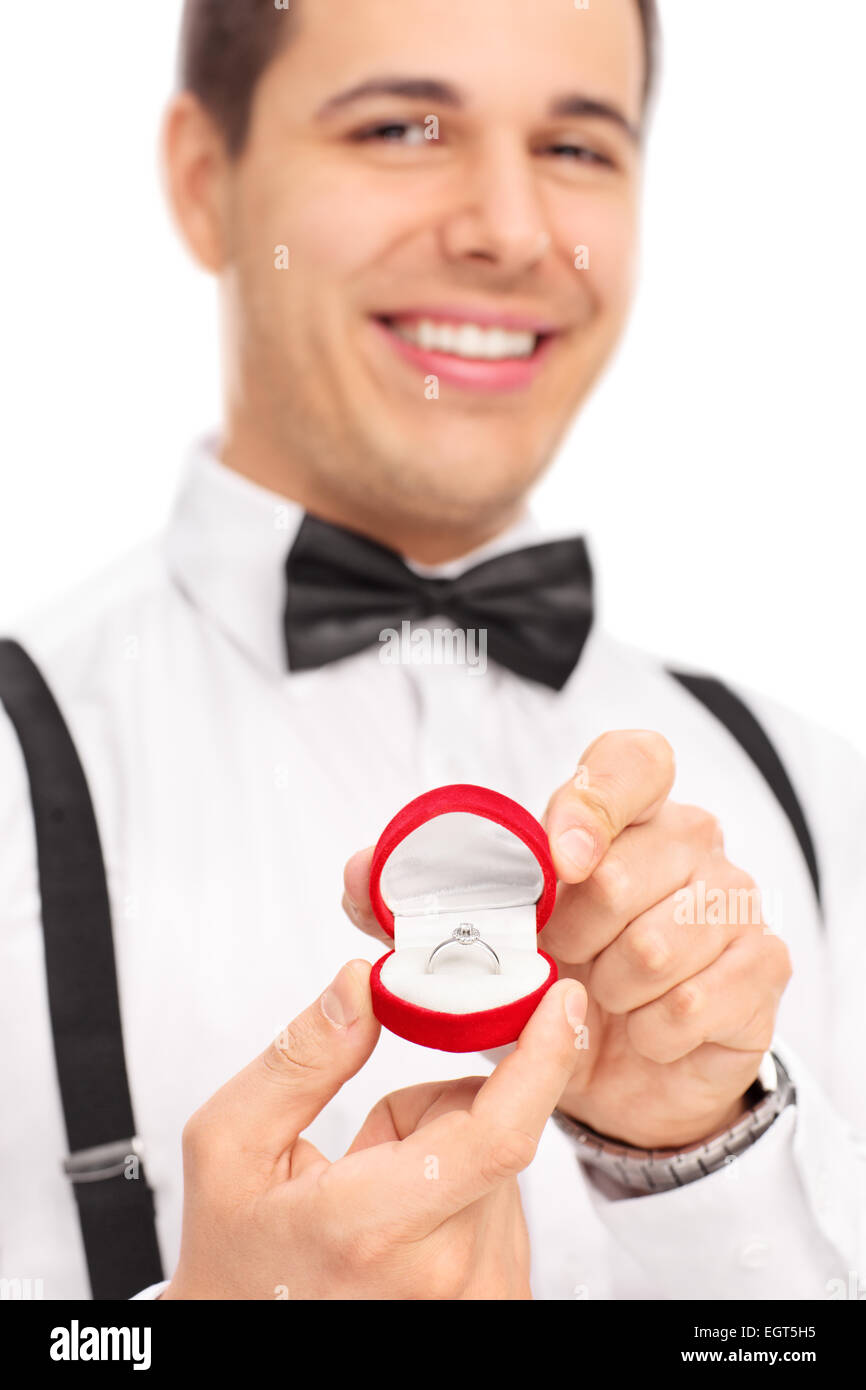 Close up on a young man holding an engagement ring with the focus on ...