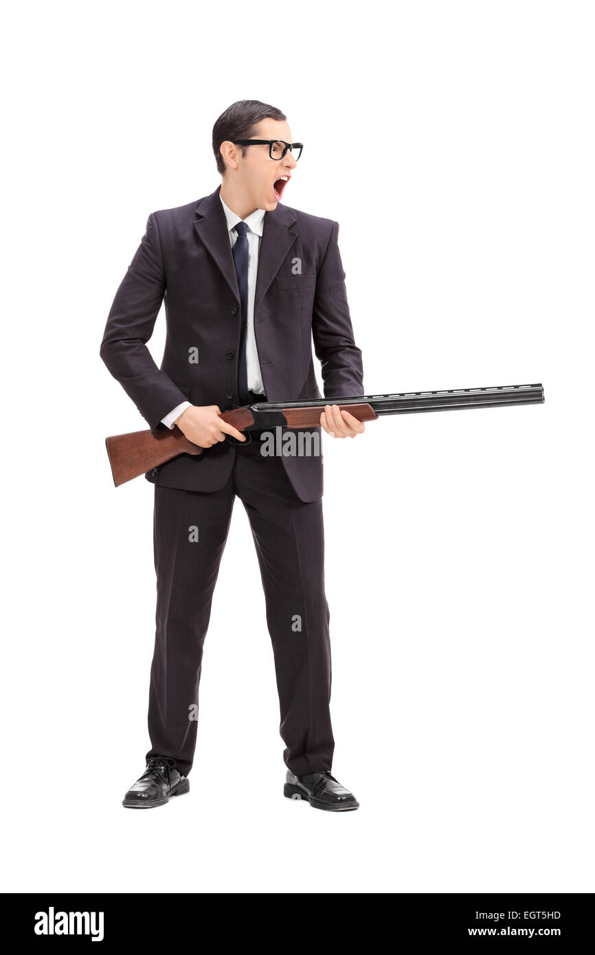 Full length portrait of an angry man holding a rifle and shouting ...