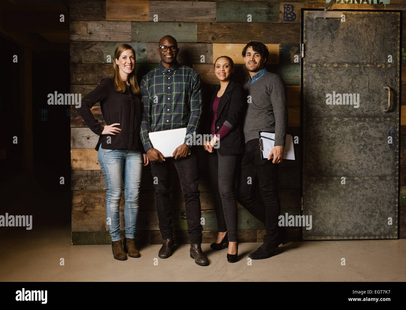 Full length portrait of successful business team standing in an office ...