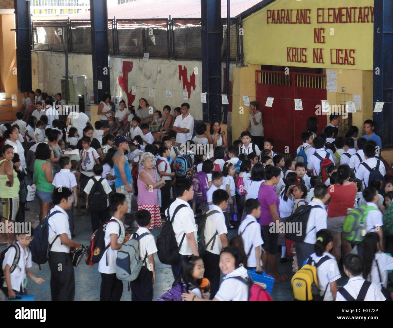 Filipino elementary students fall in line at the covered court in ...