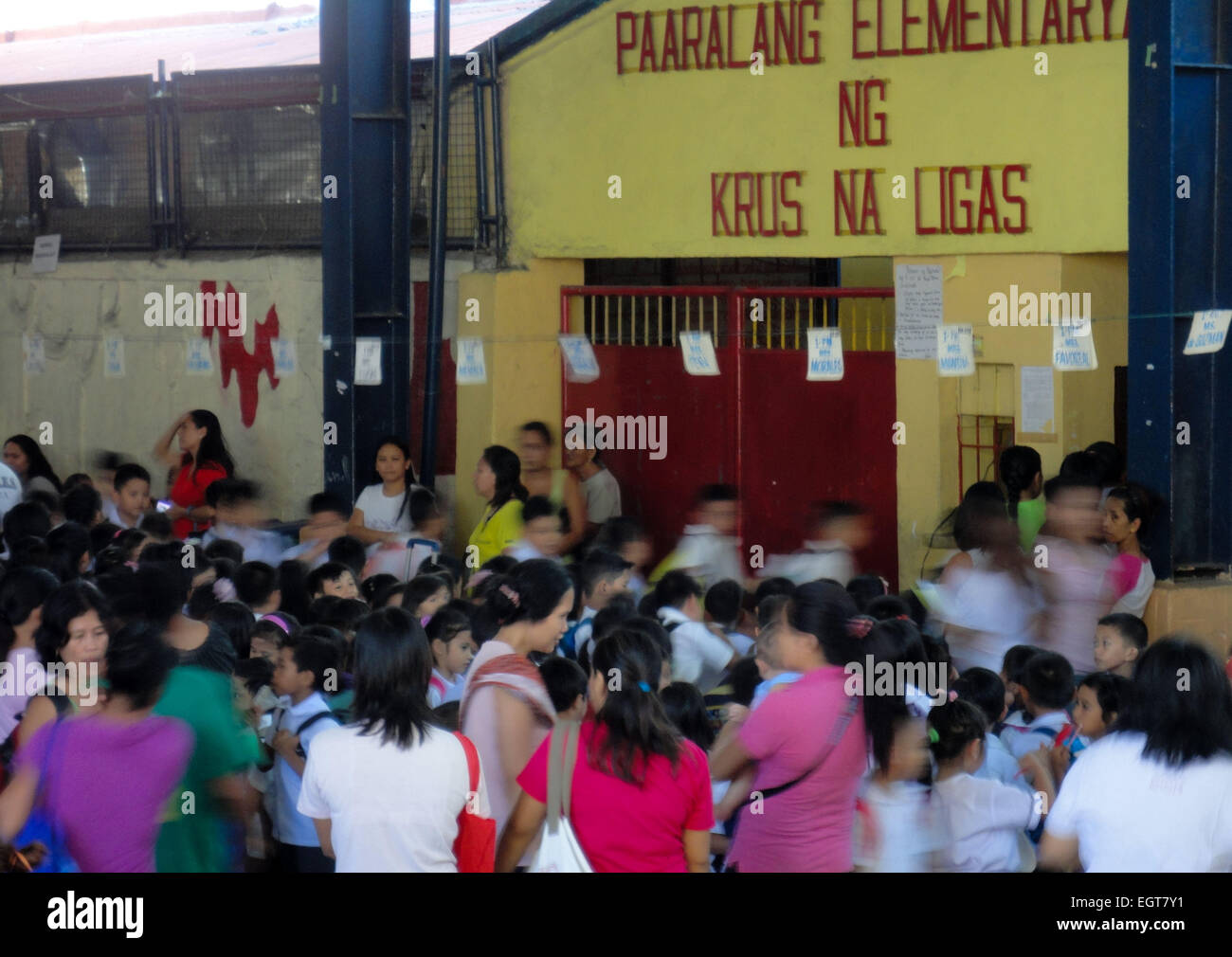 Filipino elementary students walk in a file inside a covered court at ...