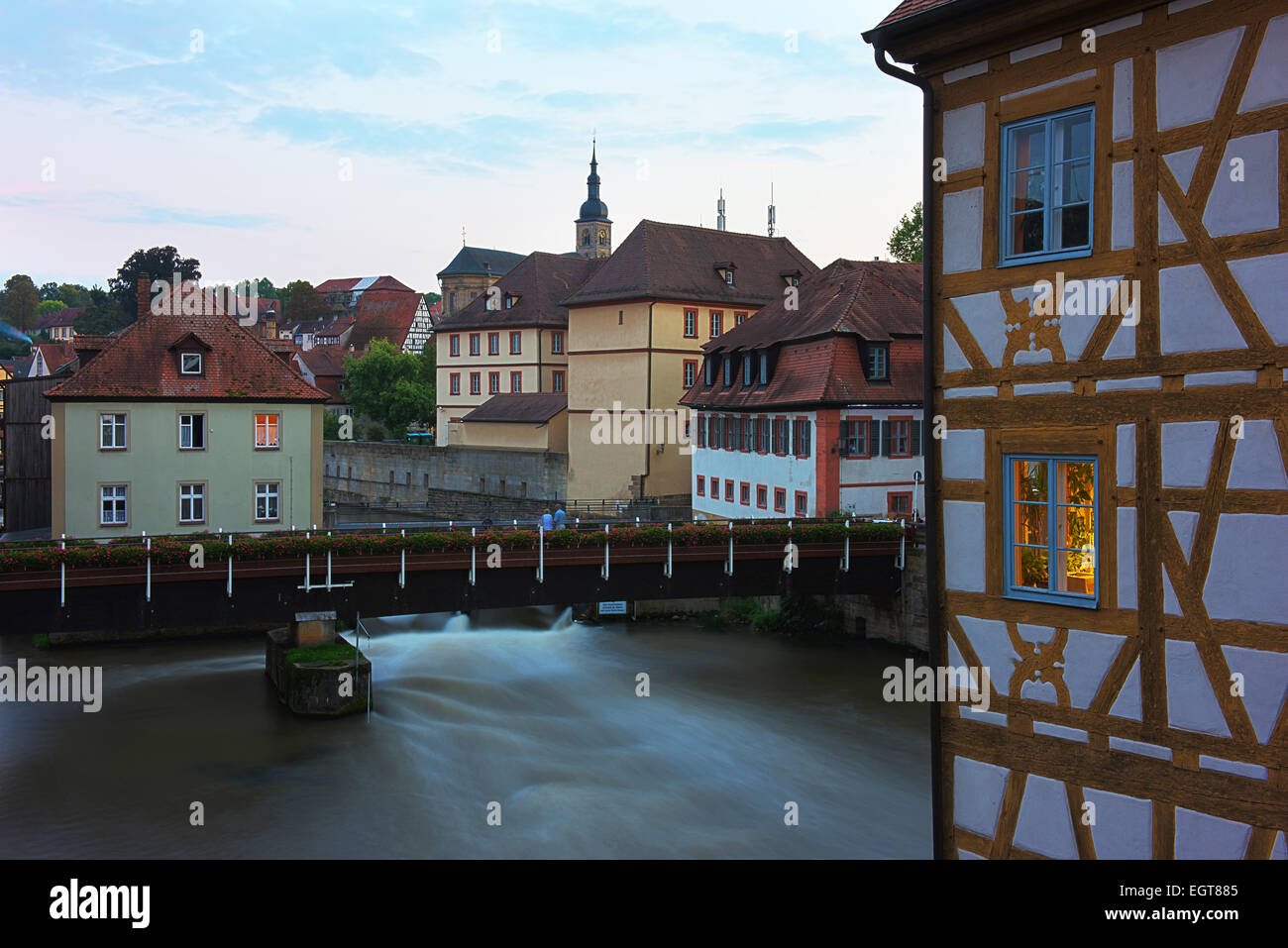 Restored historic buildings on Bamberg's Regnitz River at dusk Stock ...