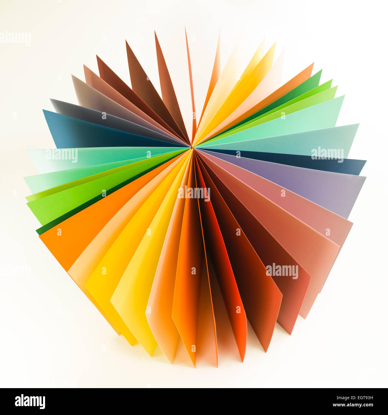 colored origami paper arranged in circle fan shape on white background ...