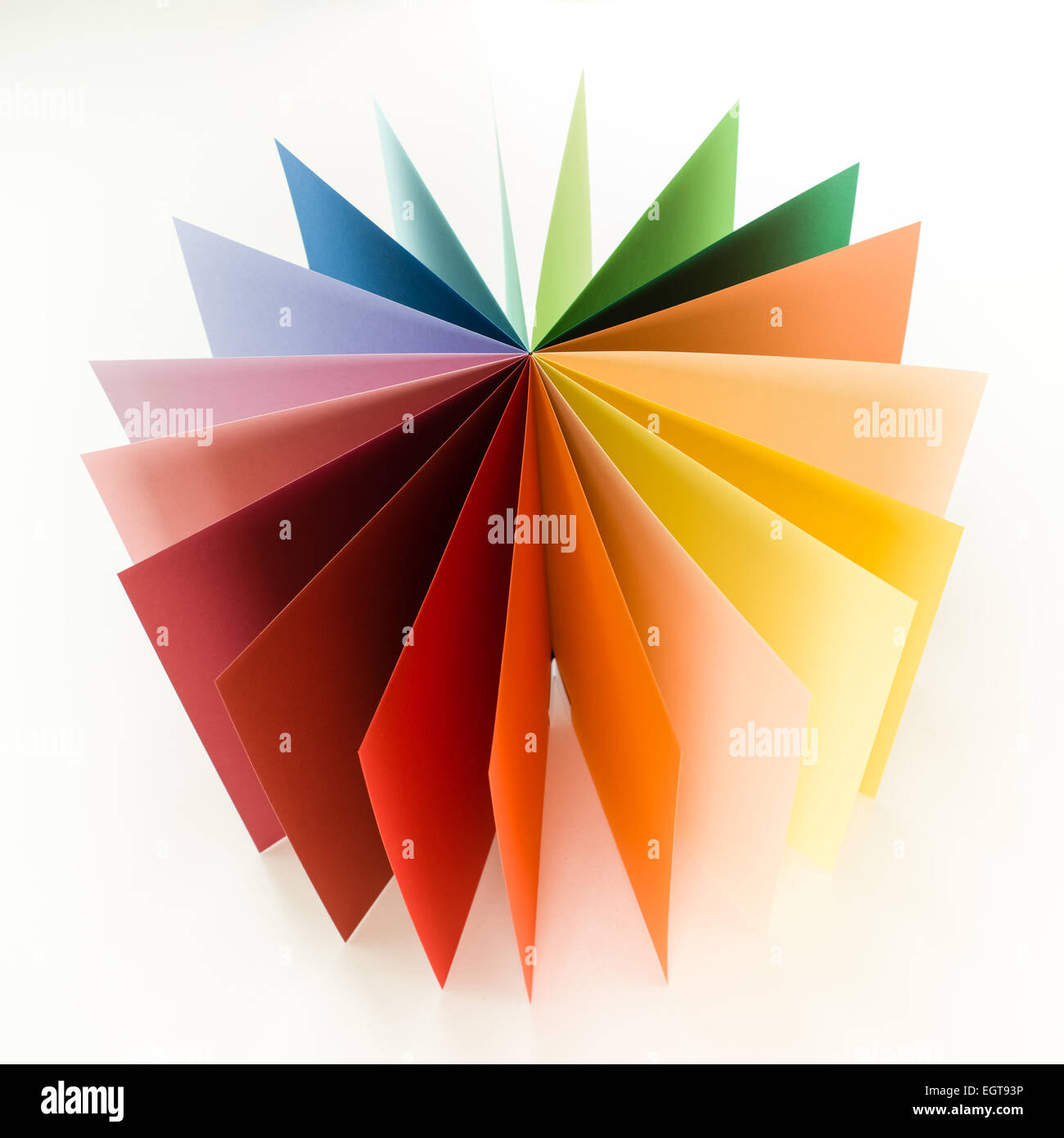 top view of colorful origami paper arranged in circle fan shape on ...