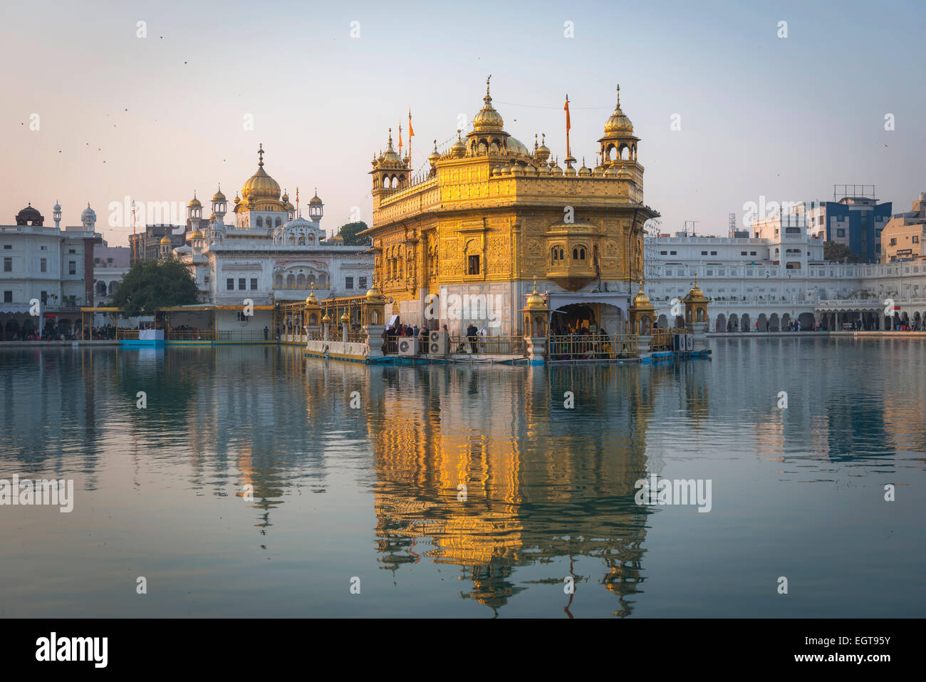 The Golden Temple of the Harmandir Sahib lit by the setting sun in ...